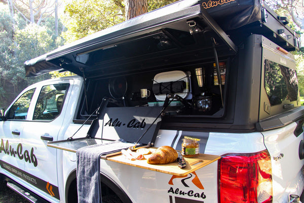Alu-Cab fold-out table with integrated bamboo cutting board